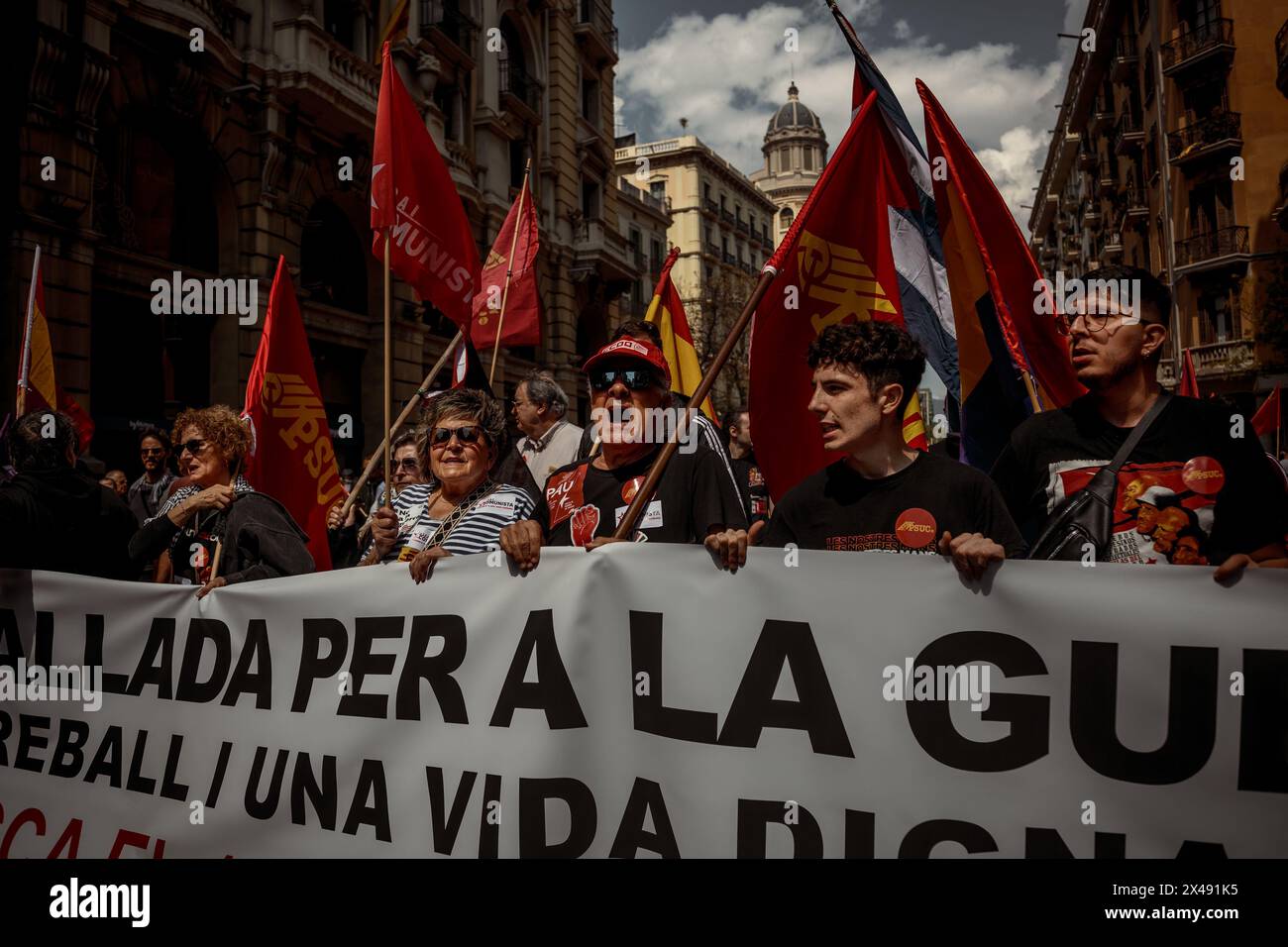 Barcelona, Spain. 1st May, 2024. Protesters holding flags march at a ...