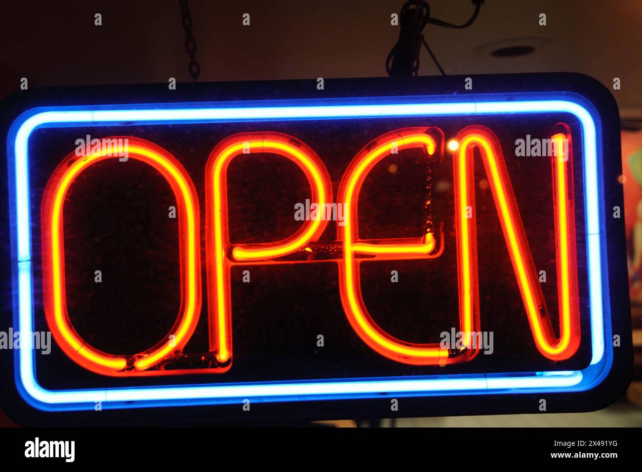 neon shining signboard with word "open" night Stock Photo - Alamy