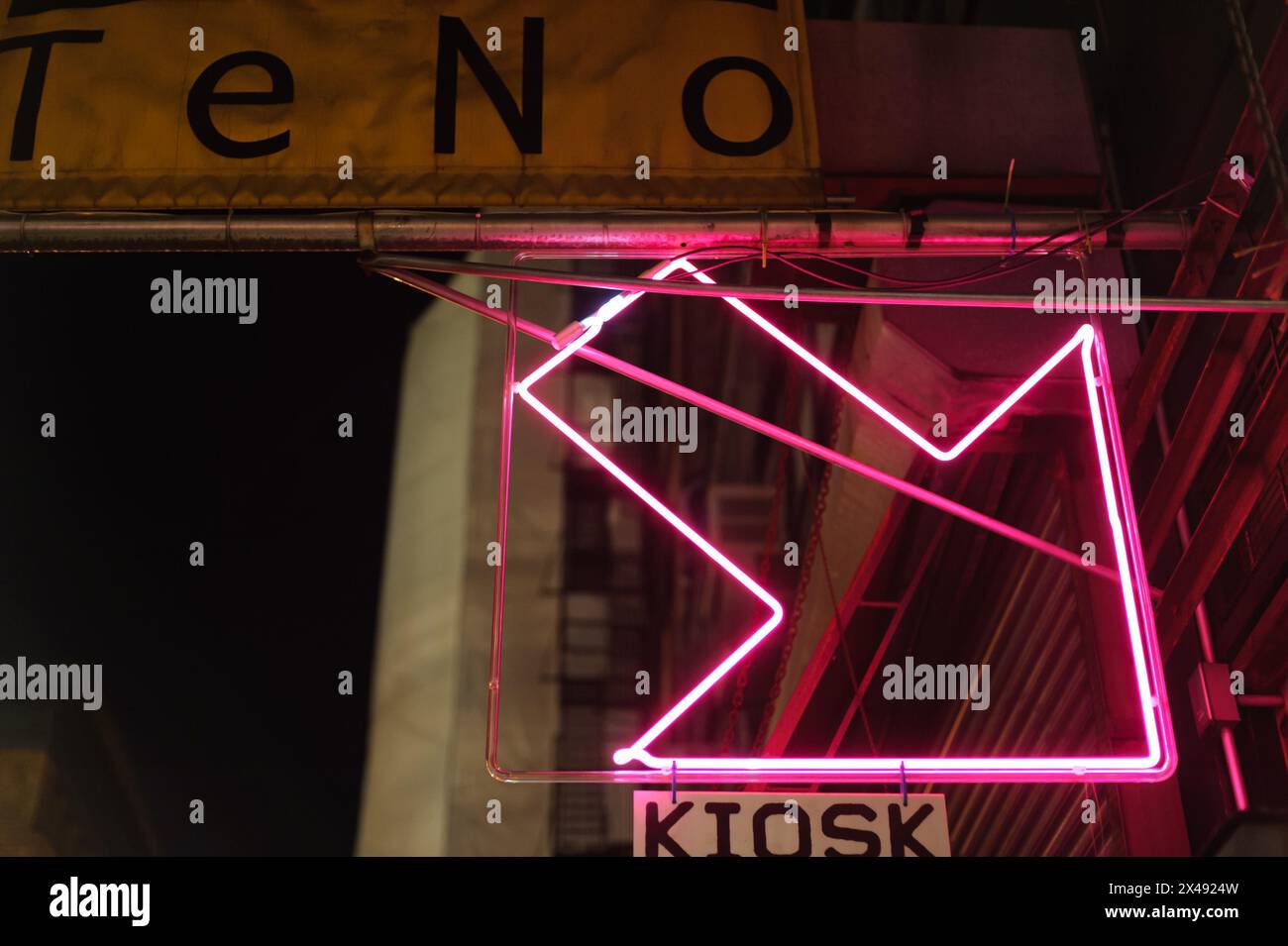 neon pink direction sign in the night Stock Photo - Alamy