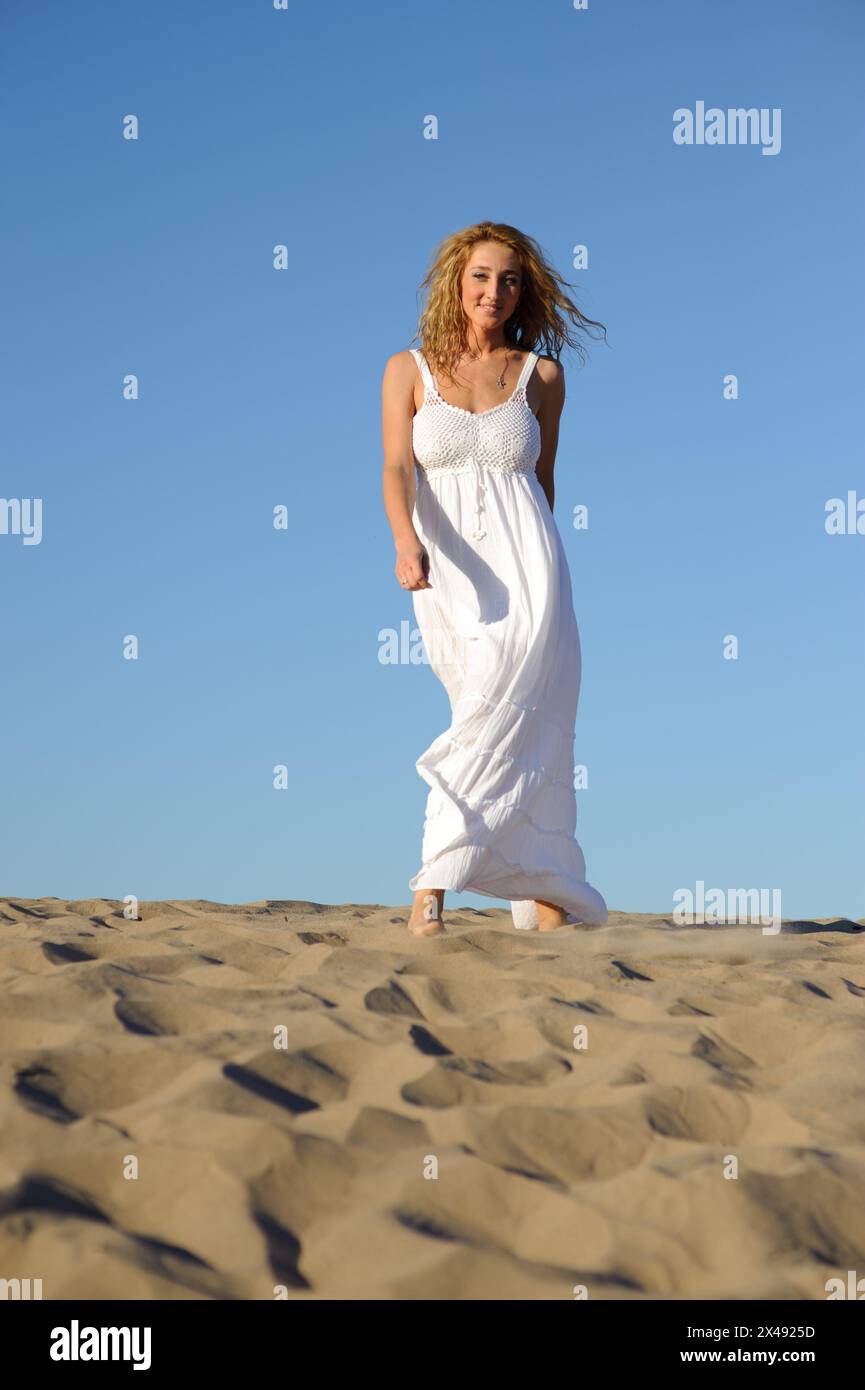 Outdoor portrait of beautiful woman in white dress, in the daytime ...