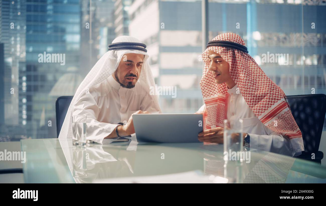 Two Successful Emirati Businessmen in White Traditional Outfit Sitting ...