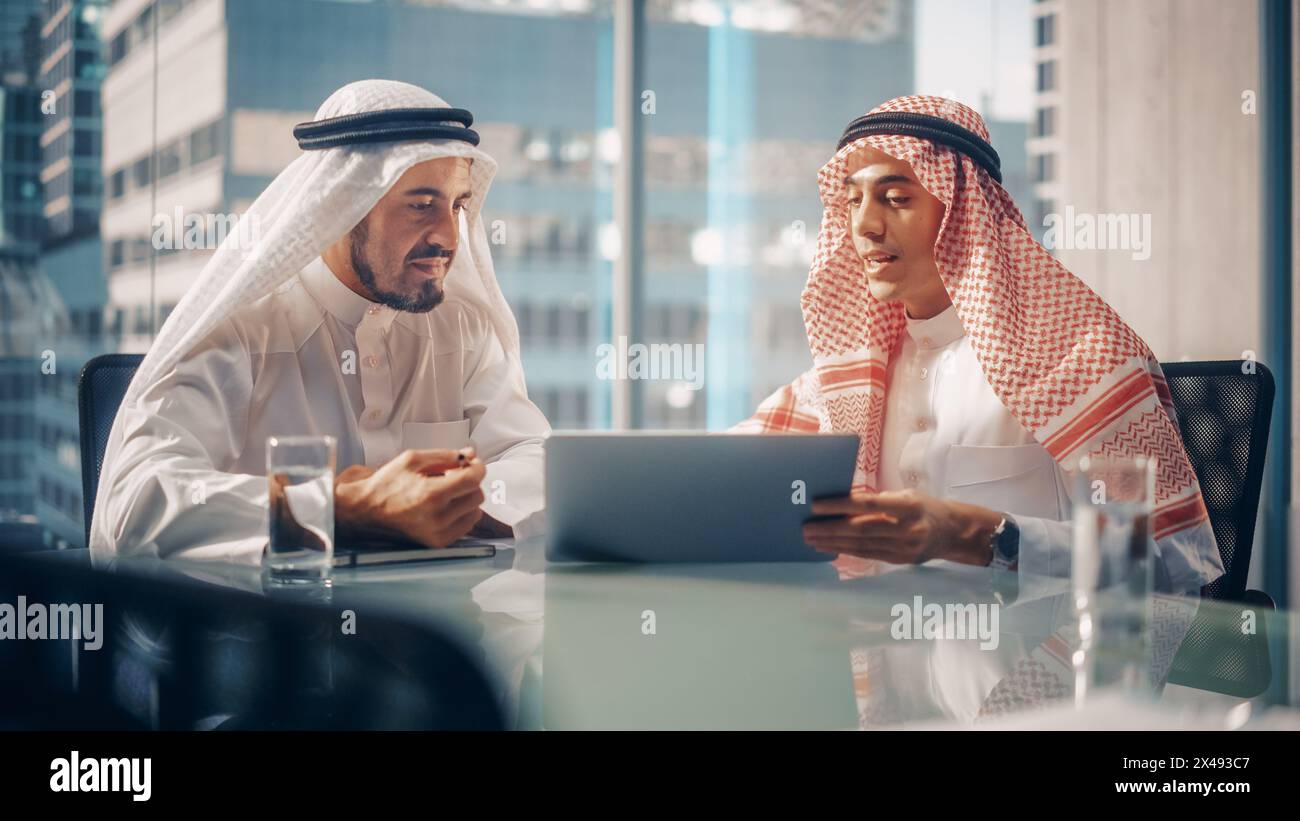 Two Successful Emirati Businessmen in White Traditional Outfit Sitting ...