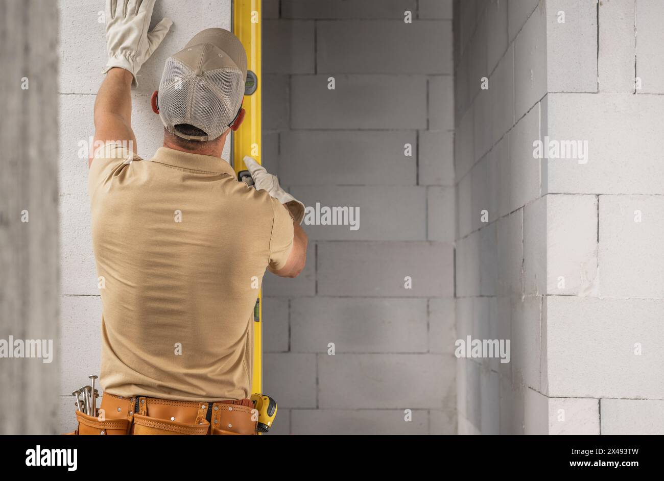 Caucasian Professional Bricklayer Worker Checking on Levels Using ...