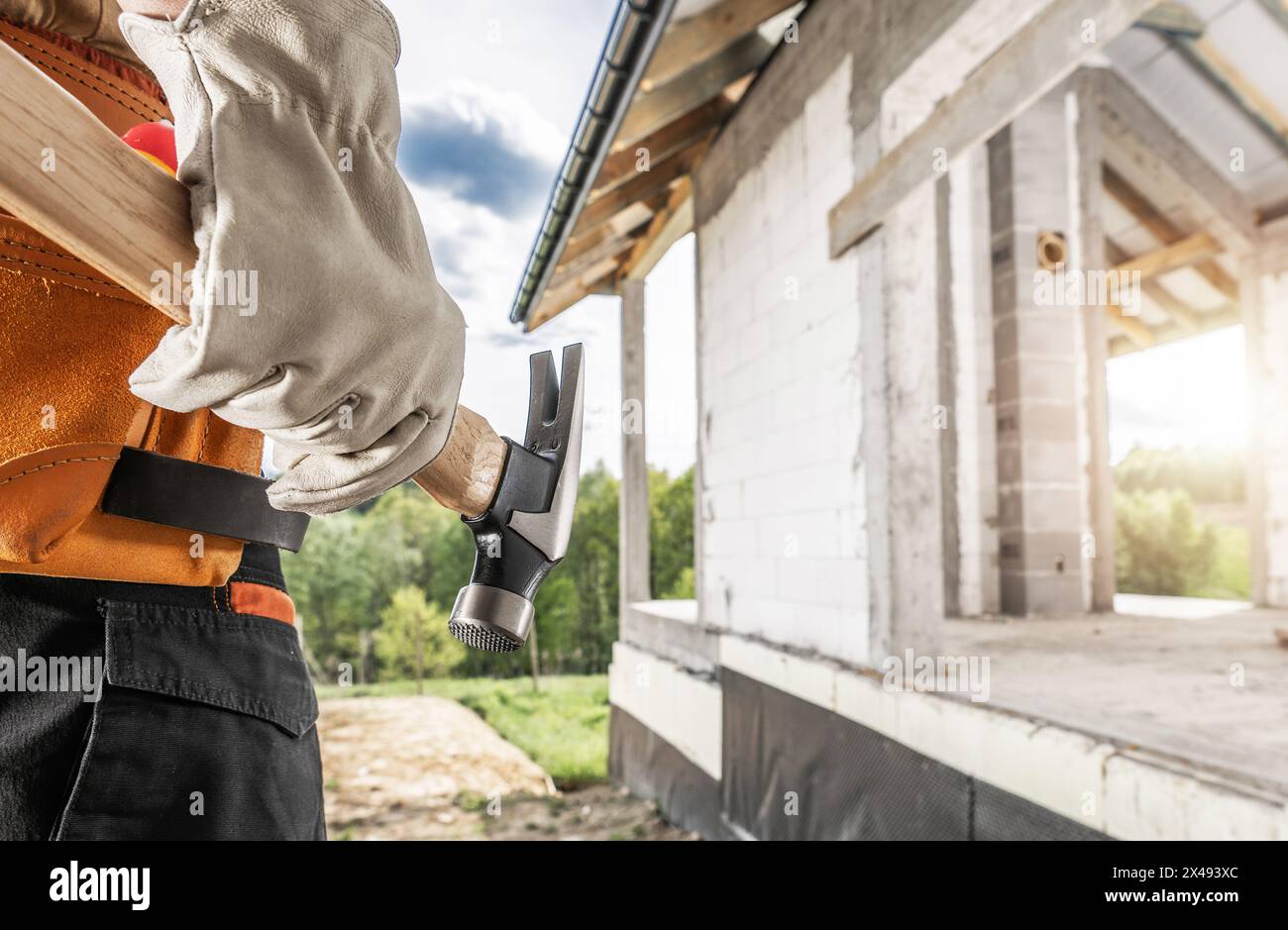 Construction Worker with a Hammer Tool in His Hand and the Newly ...