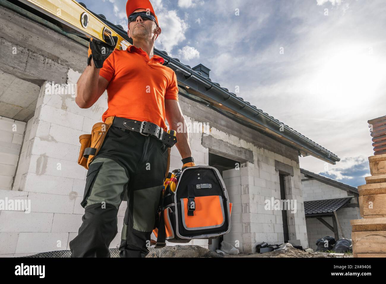 Proud Construction Worker with a Spirit Level on His Shoulder and Tool ...