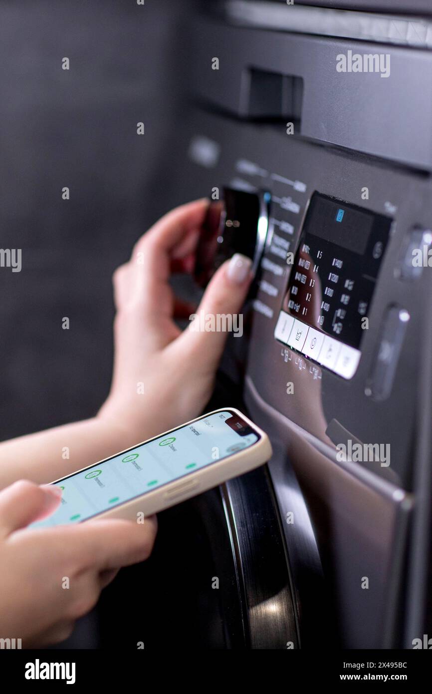Smartphone with app used to control washing machines Stock Photo - Alamy