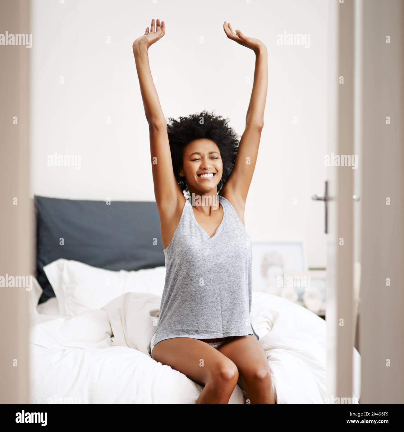 Black woman, home and happy in bed with stretching arms for waking up ...