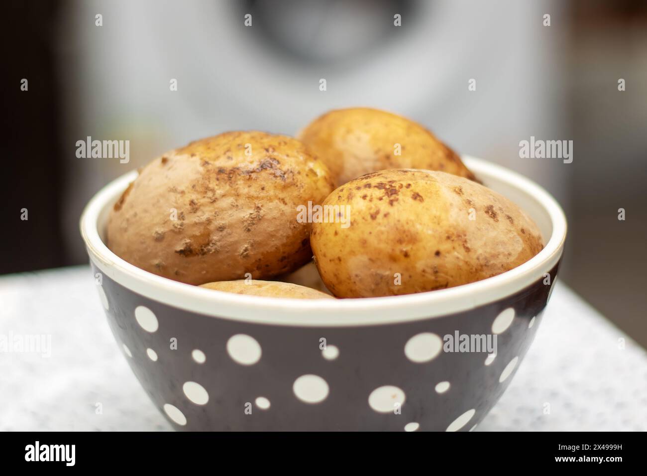 Potatoes, a staple food, are being cooked in a pan with water. These ...