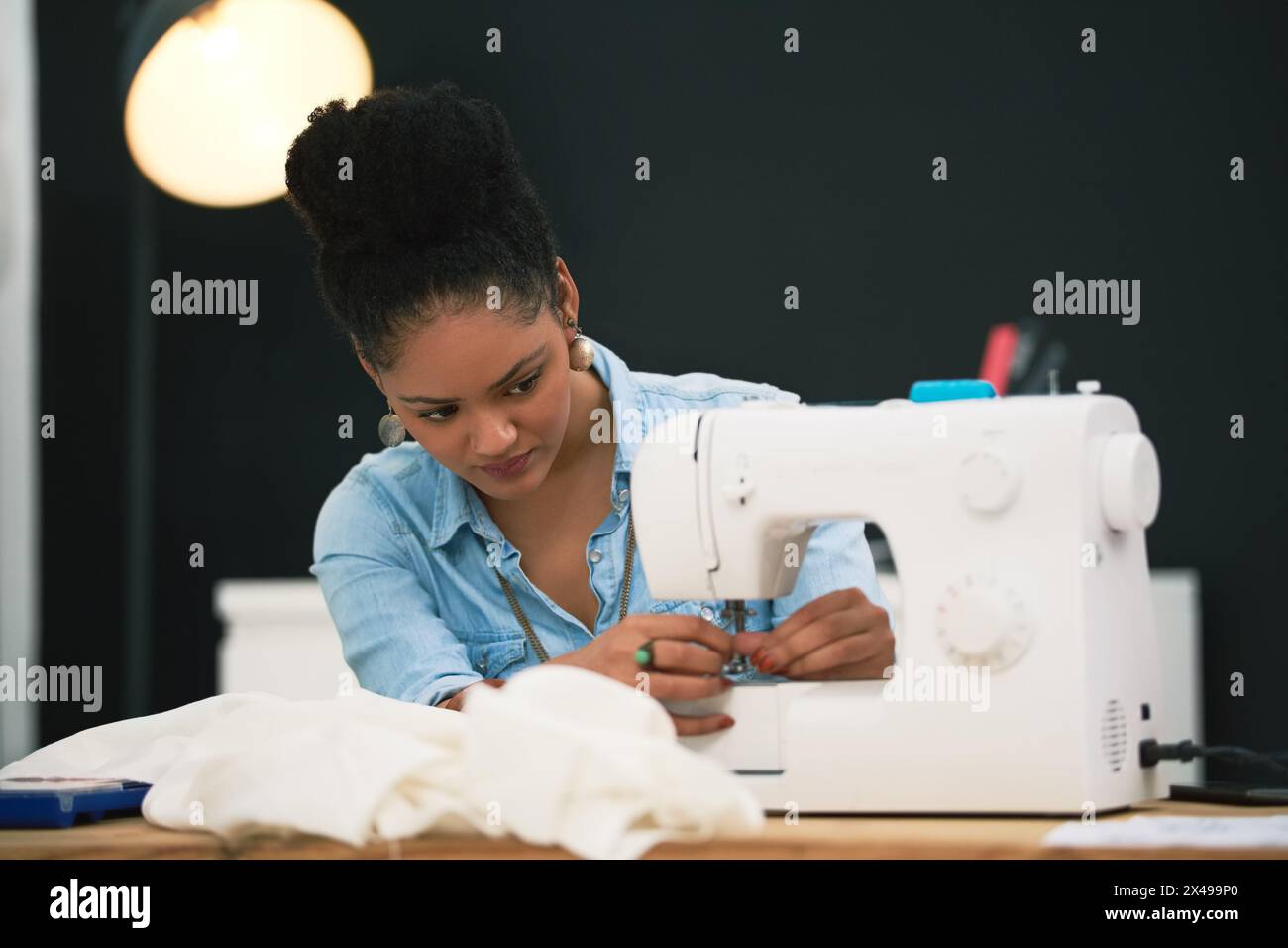 Fabric, fashion designer and woman with machine for sewing, designing ...