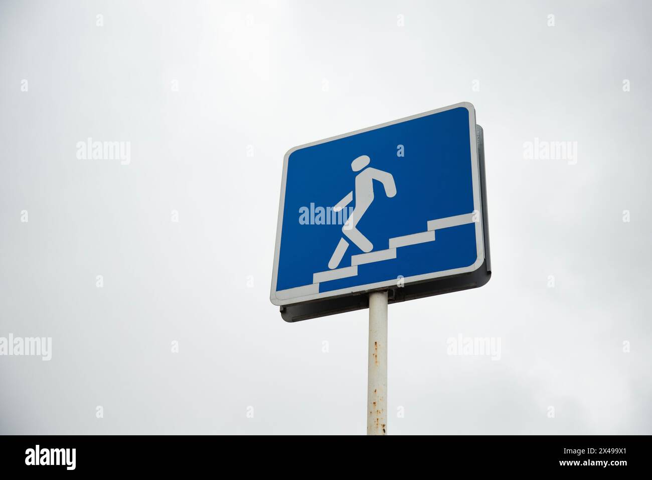 Walk down sign . Traffic sign pedestrian descending Stock Photo - Alamy