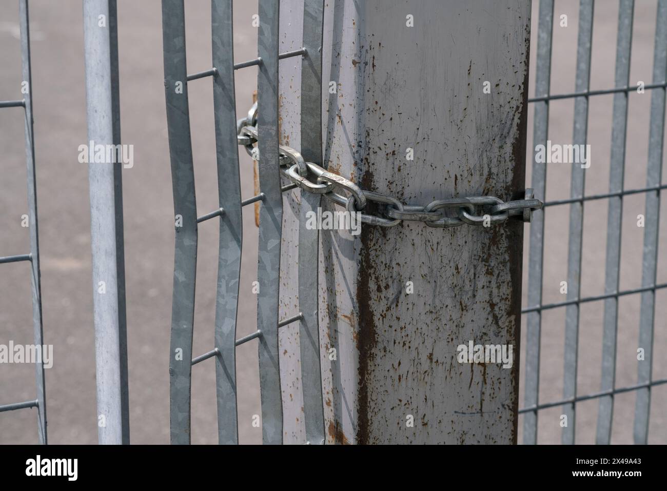 the fence with steel metal grate with chain closure. Detail of the ...