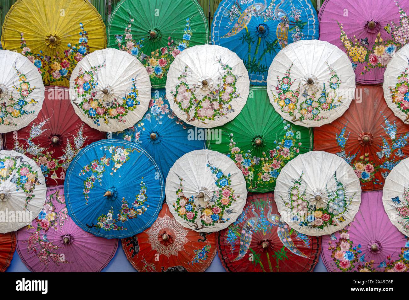 A wall of traditional umbrellas decorated with a painting Stock Photo ...