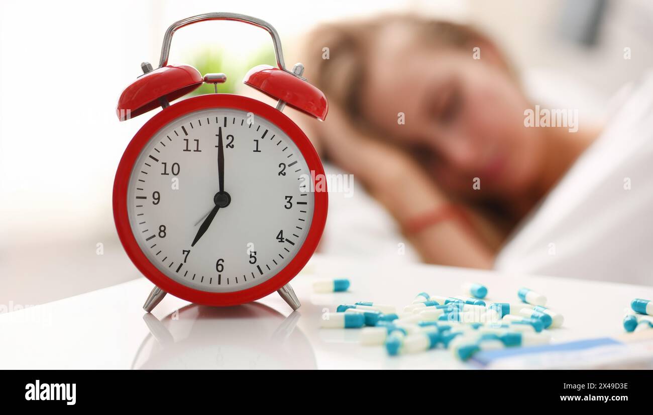 Pieces are scattered on the table near alarm clock which shows 7 am ...