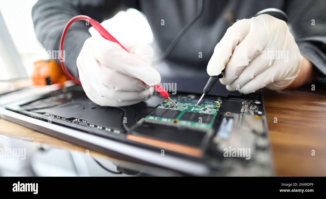 Technician soldering laptop parts Stock Photo - Alamy