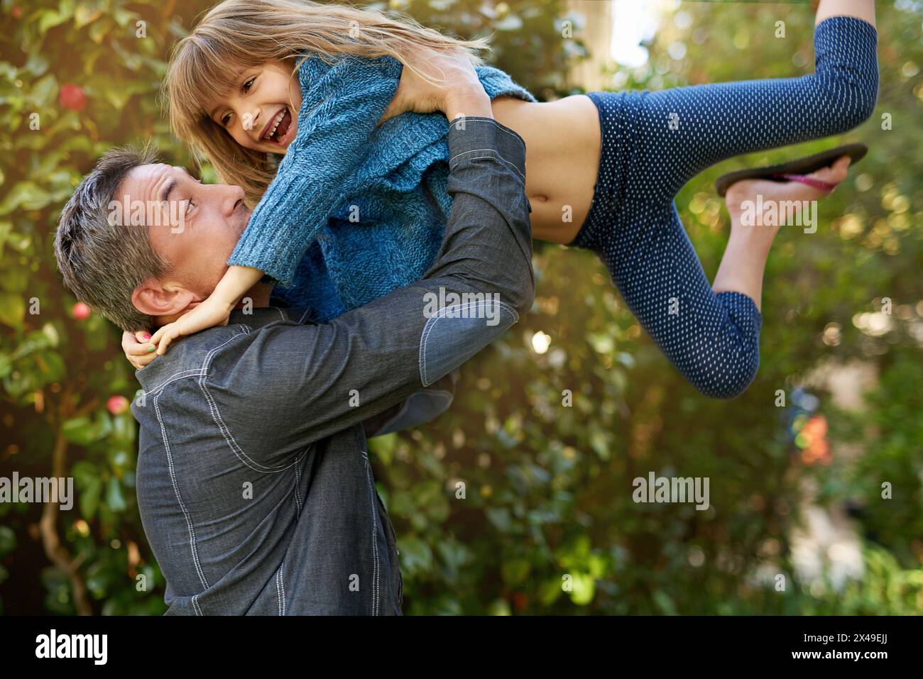 Father, girl and hug in outdoor spin, laugh and play together for ...