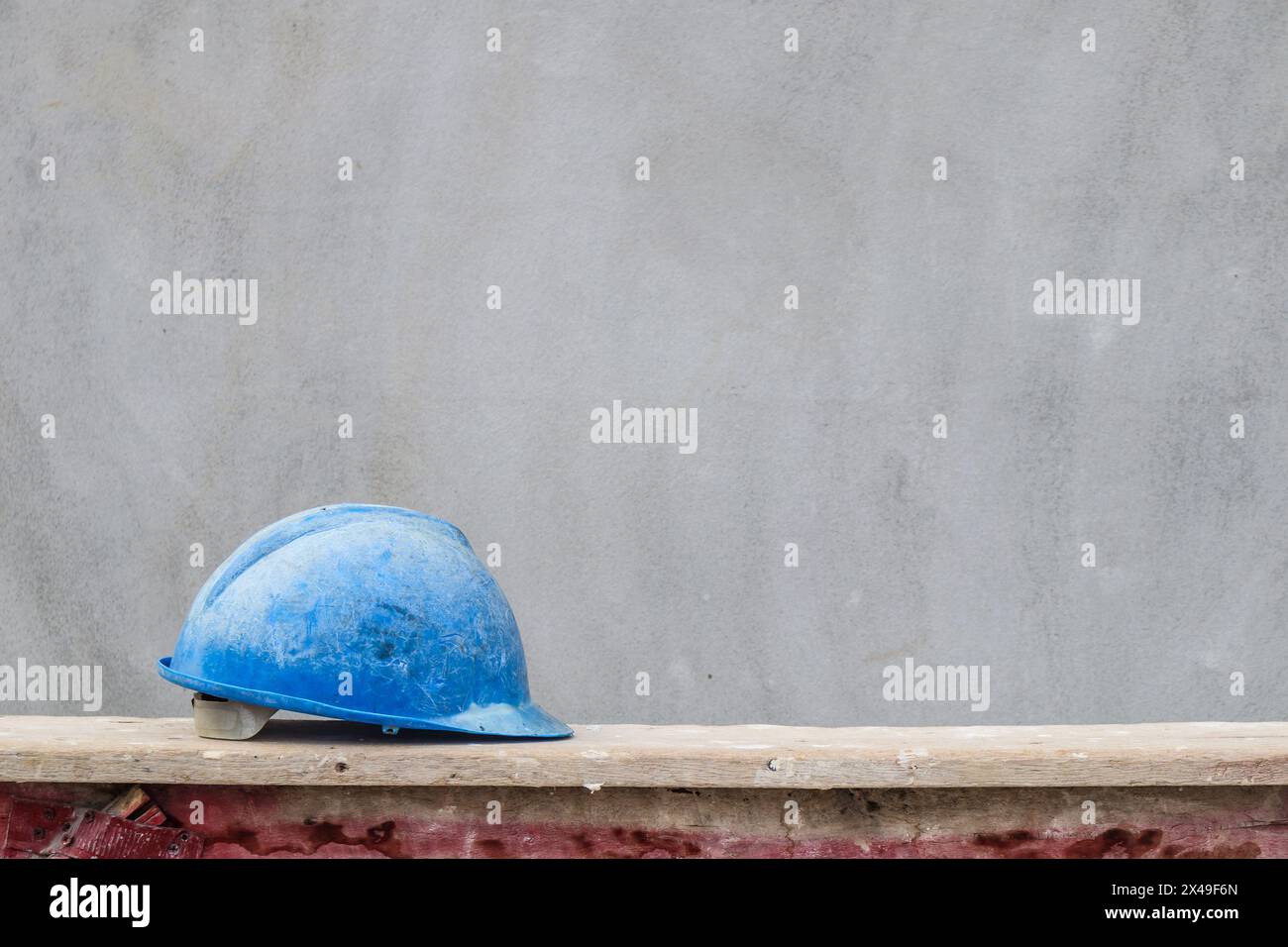 Blue hard hat on house building construction site Stock Photo - Alamy