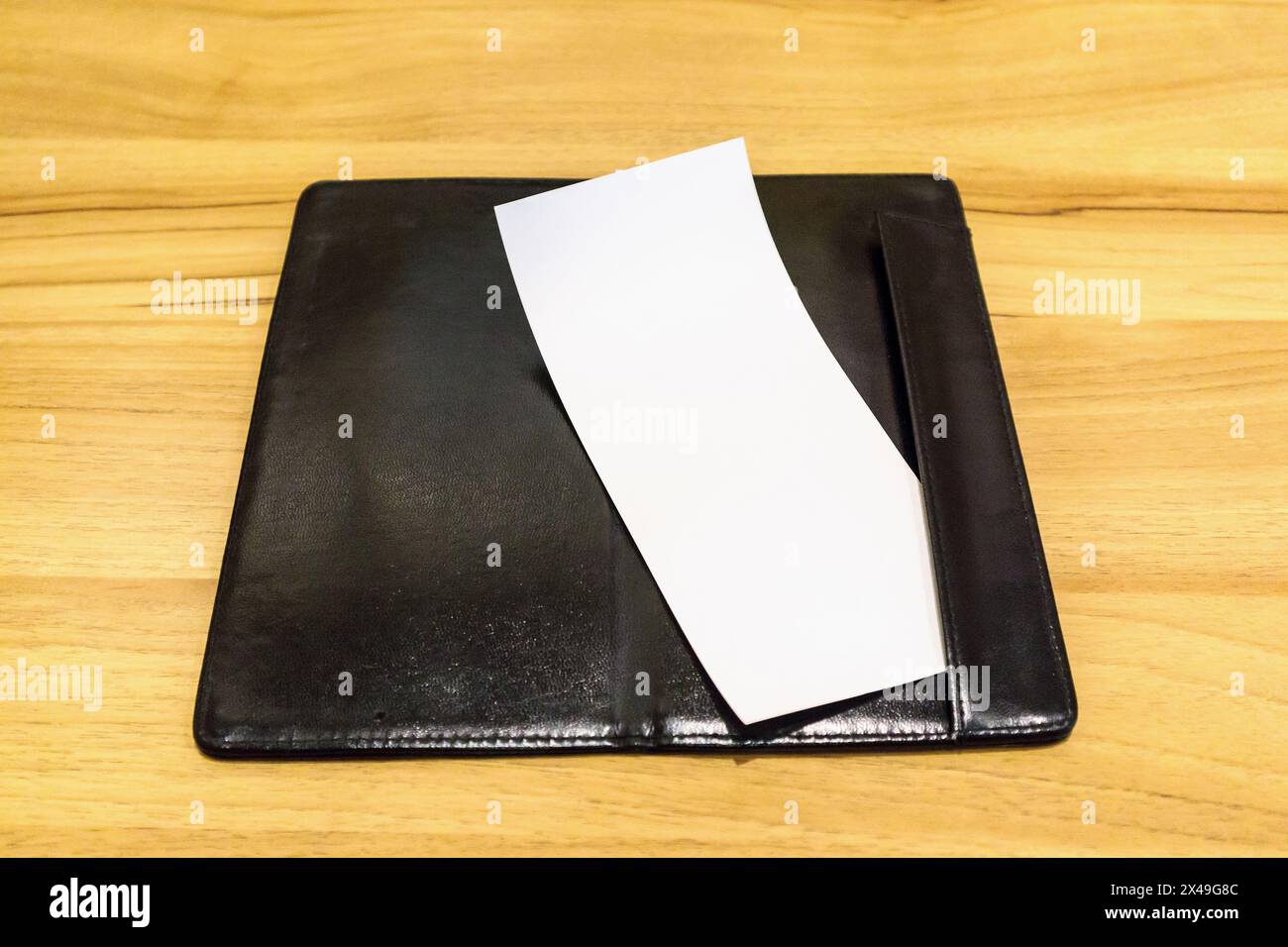Blank empty white paper in restaurant payment billing receipt folder on ...