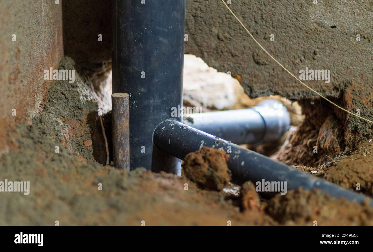 Pipe junction. A set of pipes joins to one big pipe which directs to ...