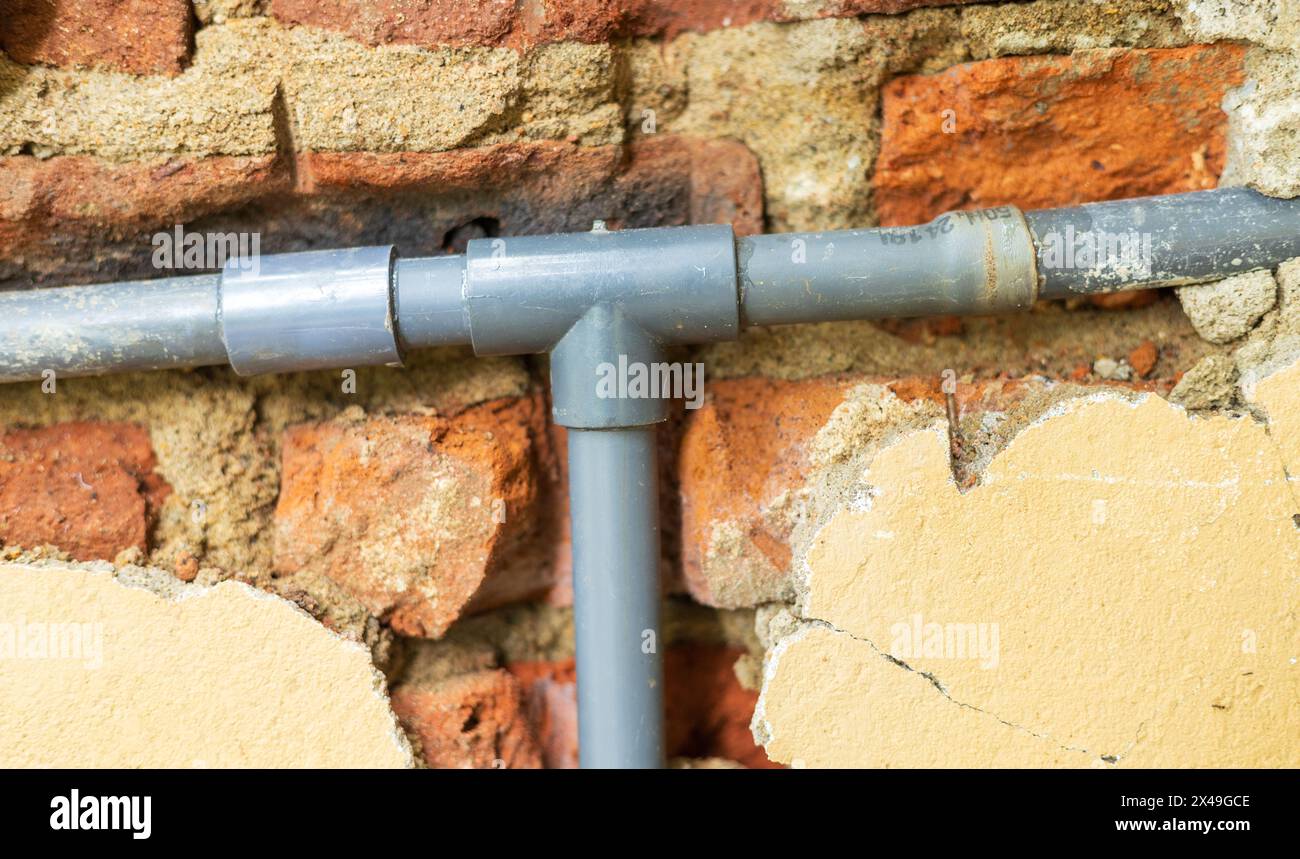 Traditional plumbing using waste pipe fitings. Brick wall plumbing ...