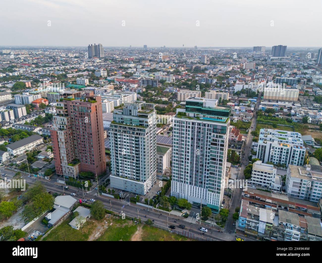 Several tall buildings with recreation areas and swimming pools on the ...
