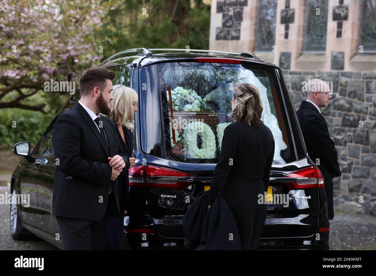 Mourners gather as the hearse, carrying the coffin of former BBC ...