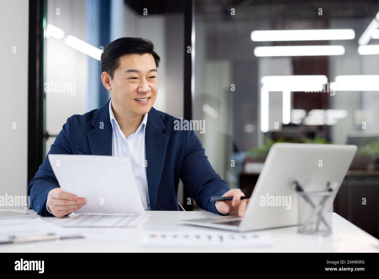 Happy person in formal clothes working by table with pc on background ...