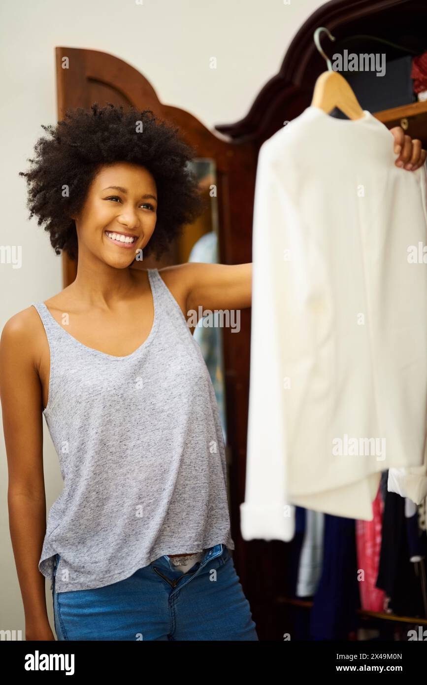 Black woman, smile and clothes choice at closet in home, getting ready ...