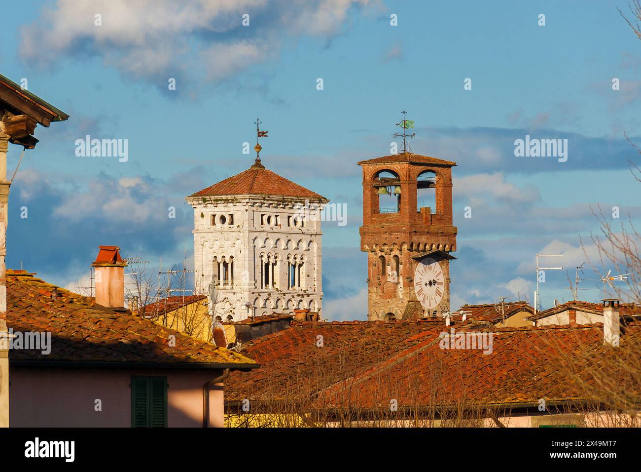 Lucca medieval clocktower and St Michael bell tower Stock Photo - Alamy