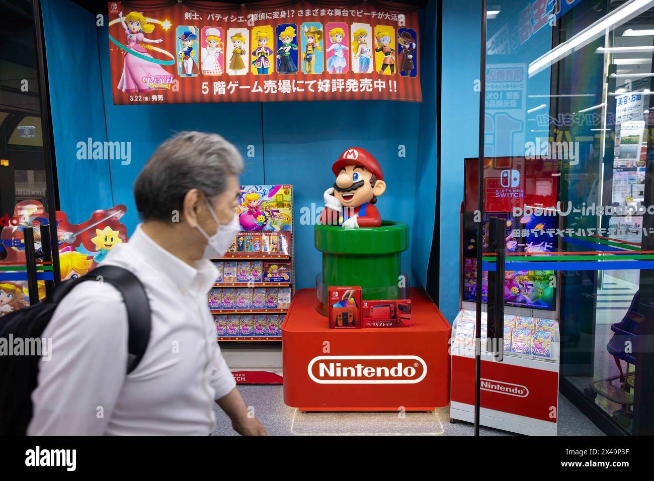 Osaka, Japan. 16th Apr, 2024. Man walks past the Nintendo display with ...