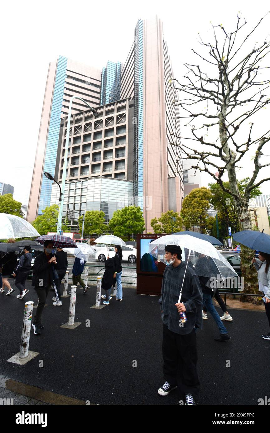 Tokyo Japan in the rain with umbrellas people hiding from the rain wet ...