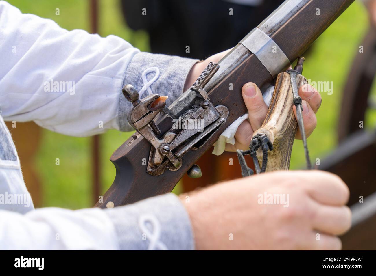 A medieval rifle with a flint firing mechanism and a bone powder holder ...