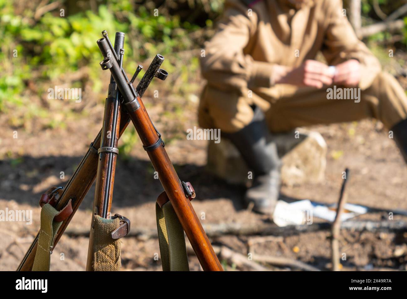 WWII rifles propped up against each other in a military camp Stock ...