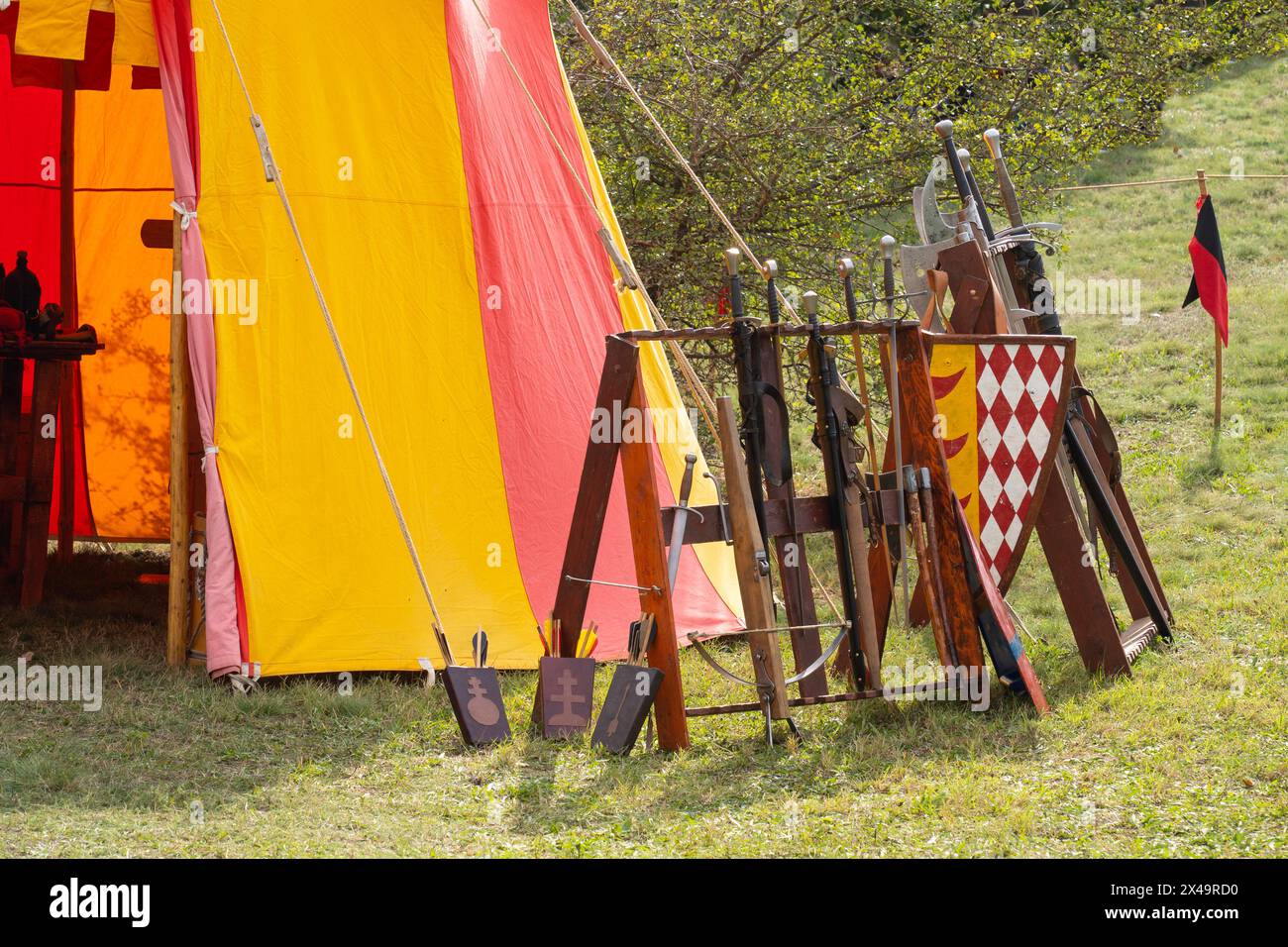 Medieval weapons next to a red yellow tent in a military camp Stock ...