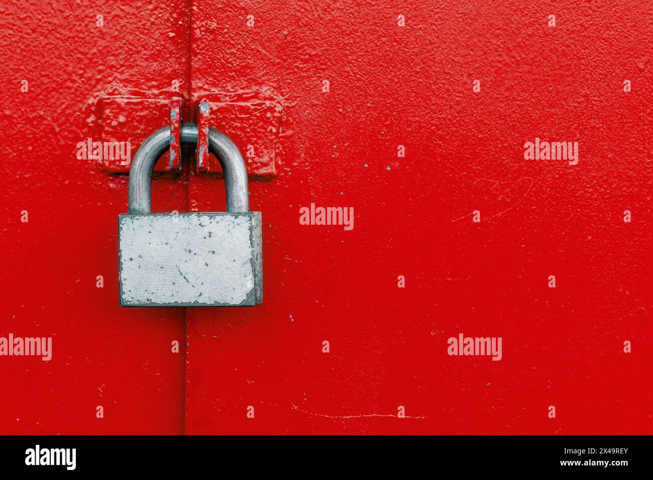 Padlock on a steel red door. Lock on the gate. Safety Stock Photo - Alamy