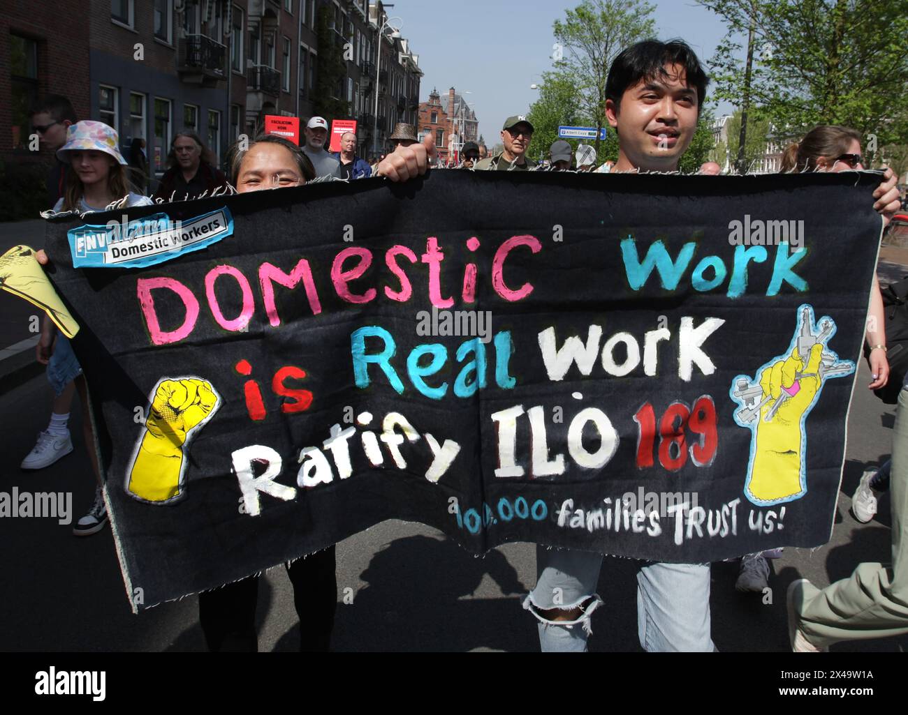 Domestic workers hold a sing take part during marches protests on May 1 ...