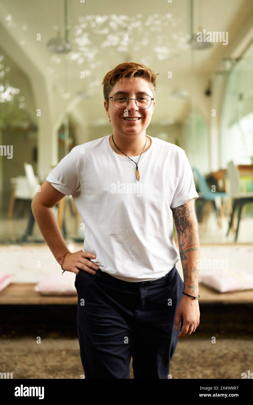 Transgender employee in smart casual attire stands confidently in ...