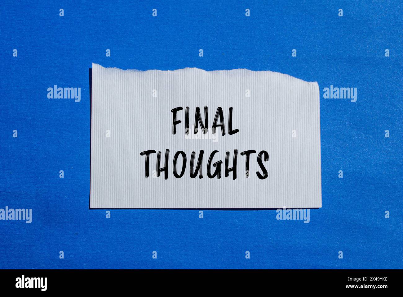 Final thoughts words written on ripped white paper piece with blue ...