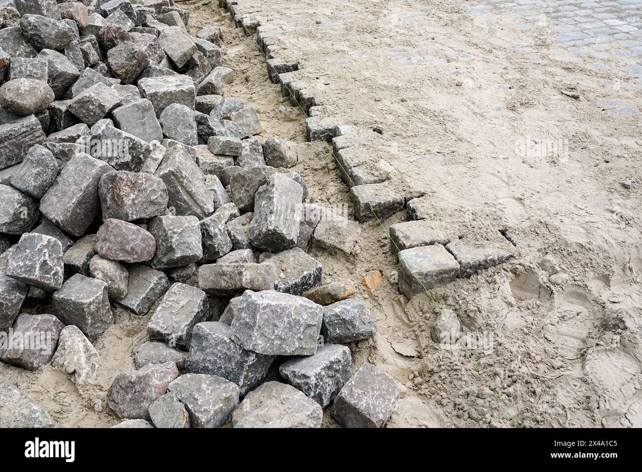 Street paving with historical hammered granite paving stones, city ...
