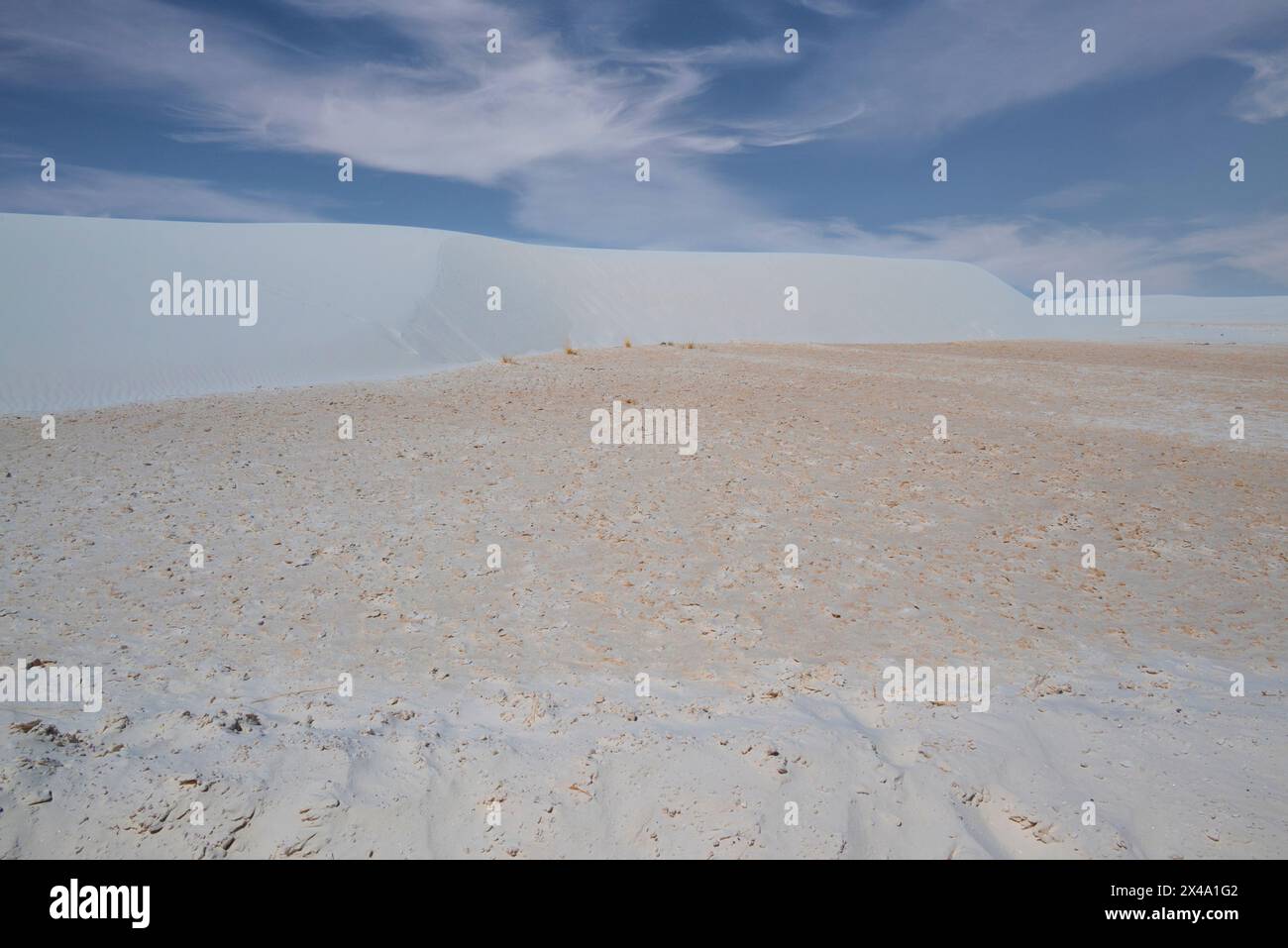 Open expanse of white gypsum with dunes in the distance at White Sands ...