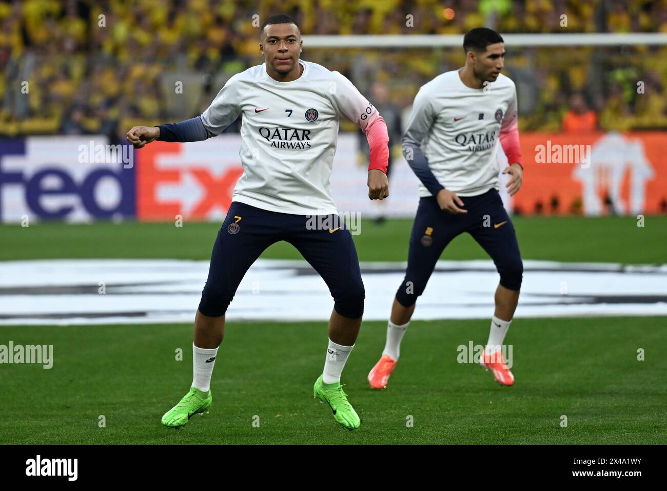 Paris Saint-Germain's Kylian Mbappe (left) warming up before the UEFA ...