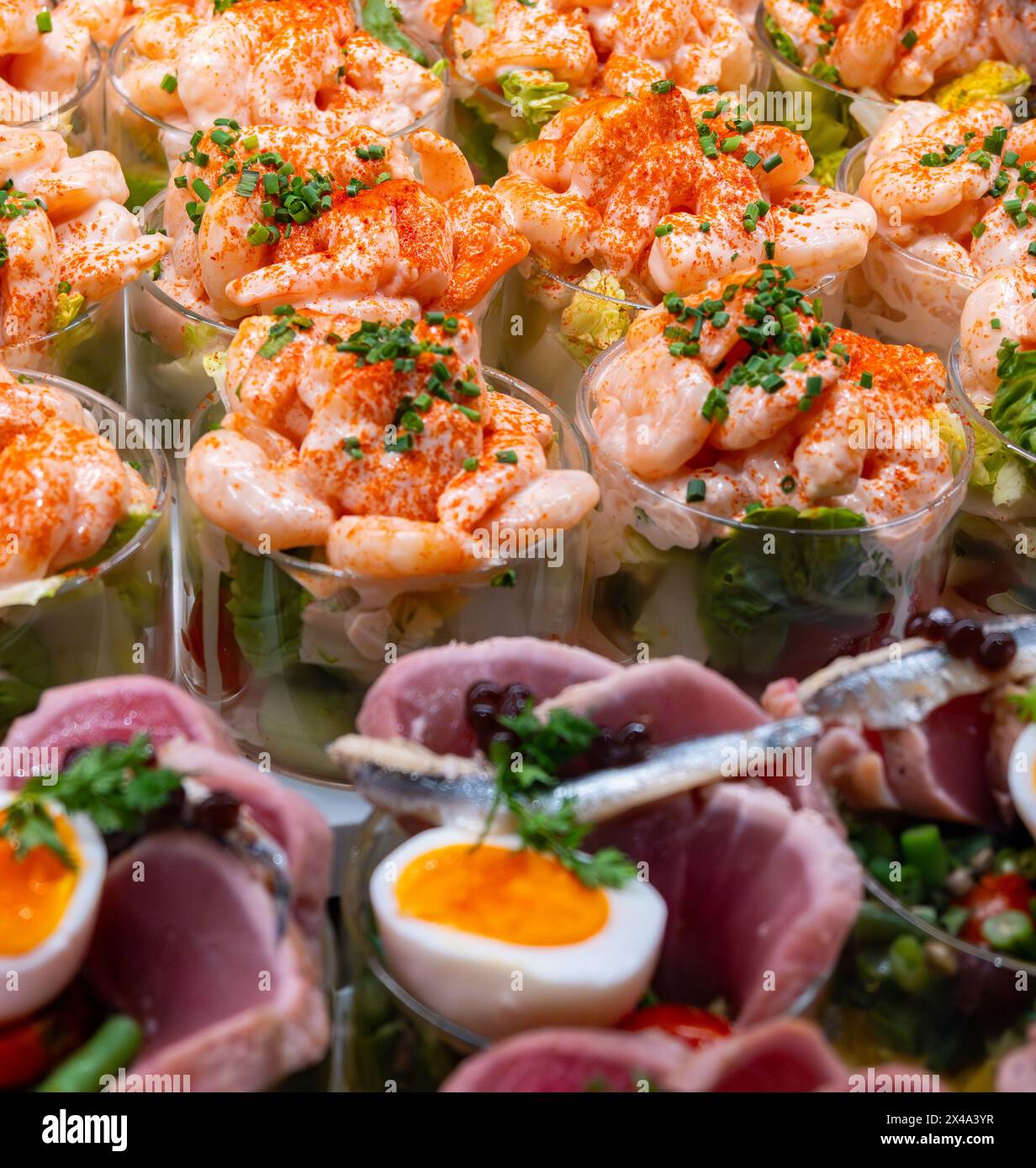 Fancy appetisers in glasses made with deafood, tuna fish, eggs ...