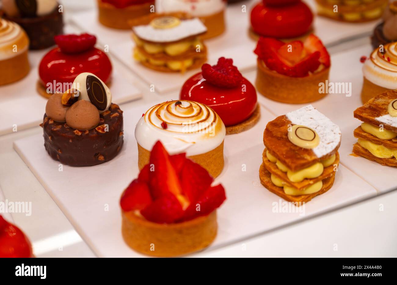 Various sweet cakes meringue, red fruits and berries framboise tartlets ...