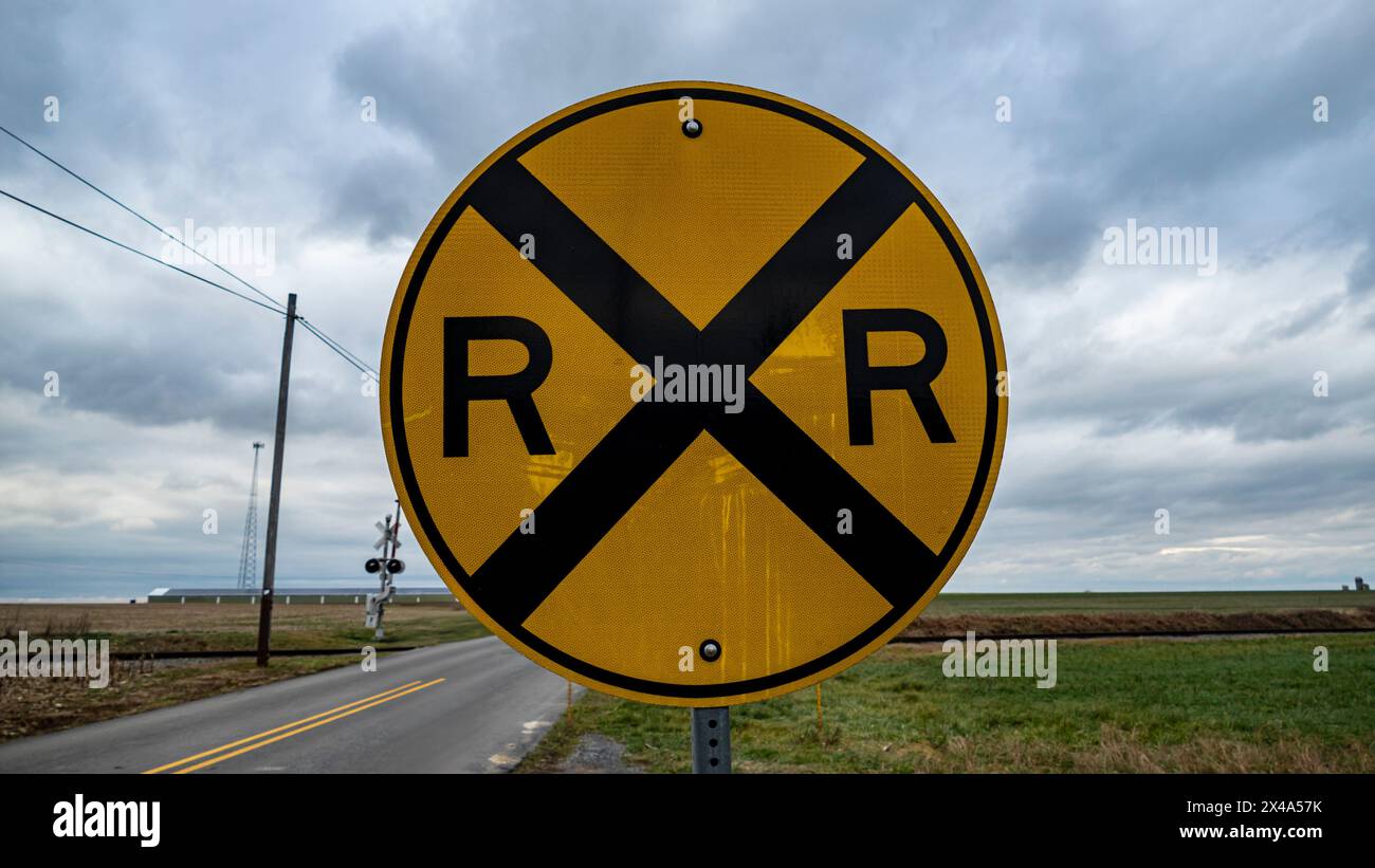 A yellow and black sign with the letters R and X on it. The sign is on ...