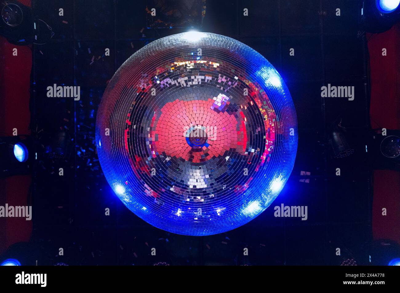 Classic large disco ball made of small mirrors reflecting bright and ...