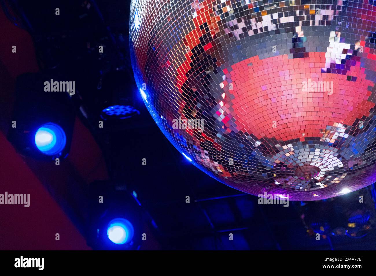 Classic large disco ball made of small mirrors reflecting bright and ...