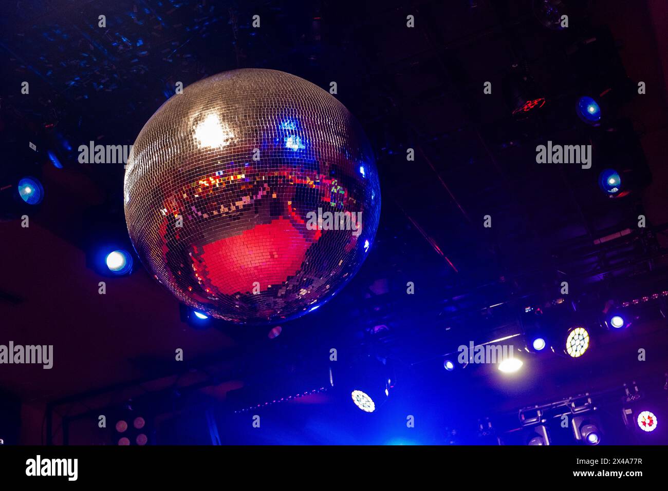 Classic large disco ball made of small mirrors reflecting bright and ...