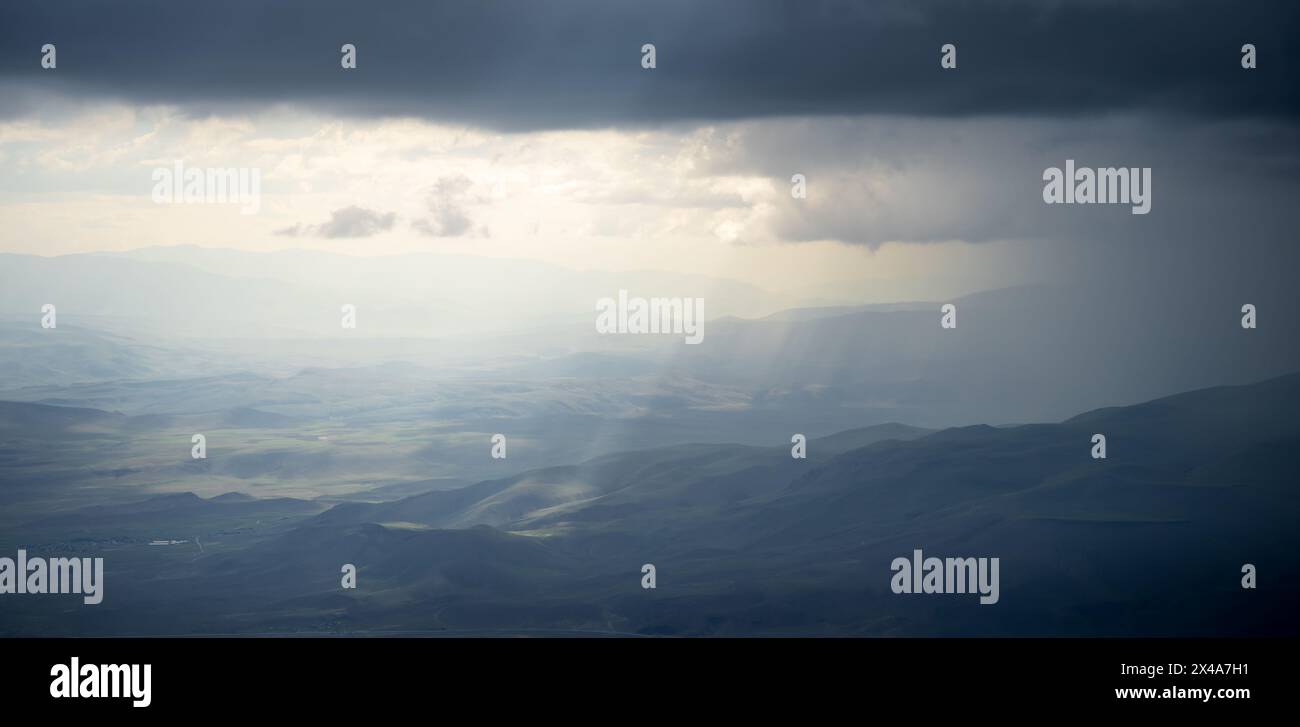 Highlands landscape with mountains, thick clouds and soft sunlight ...