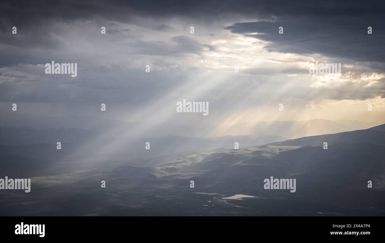 Beautiful mountainous landscape hit by beams of sunlight shining ...
