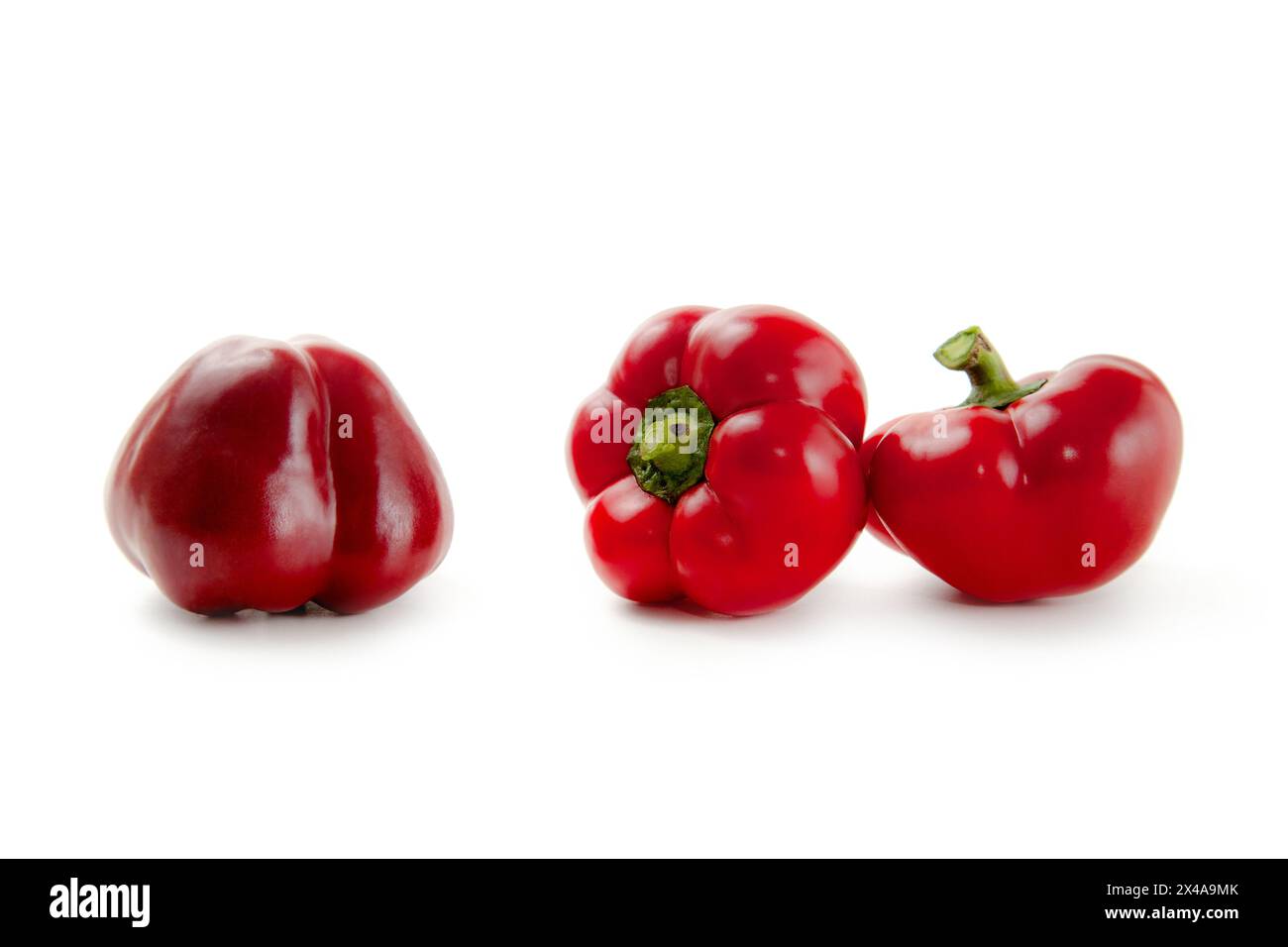 Three round red bell pepper (capsicum) known as sweet bell pepper ...