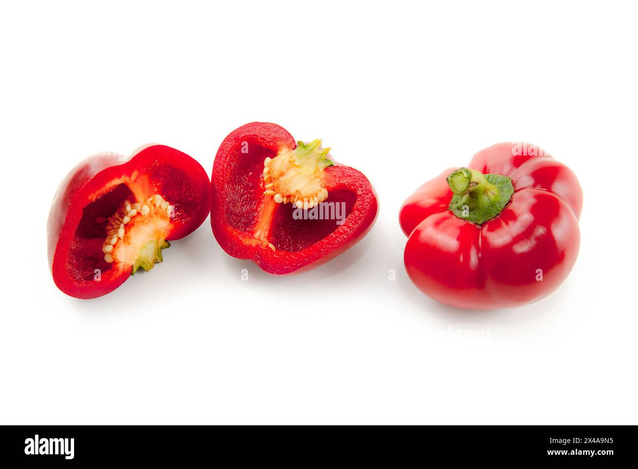 Whole and half of red bell pepper (capsicum) known as sweet bell pepper ...